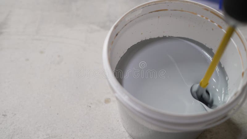 Painter Mixing Gray Paint in Bucket with Mixer Mounted on Drill Stock ...