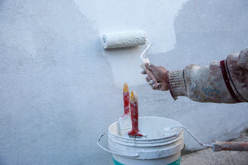 Painter Painting the Wall with Paint Roller and Bucket Stock Photo ...