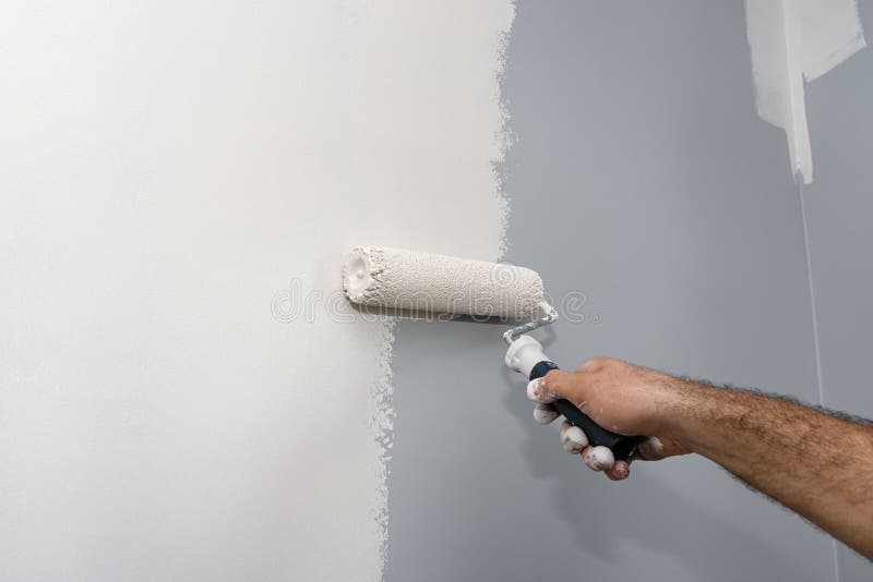 Painter Paints a Room in Beige Color Using a Paint Roller at Home ...