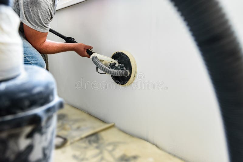 Painter Polishing and Sanding Wall Surface after Putty for Painting in ...