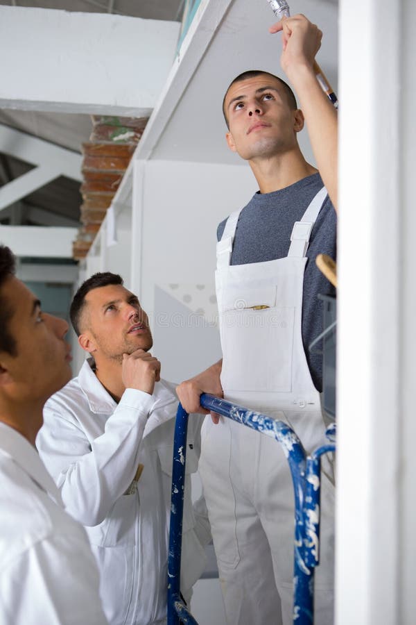 Painter touching ceiling stock image. Image of painter - 258968371