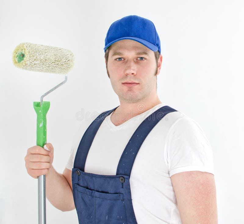 Painter in Uniform Holding Paint Roller while Standing Near Colleague ...