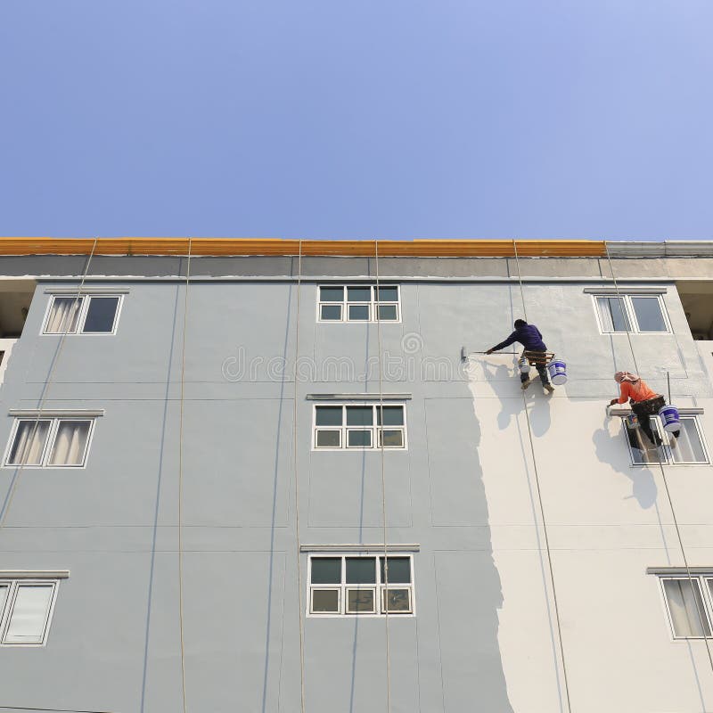 The Painter Uses a Paint Roller Outside High Building Stock Image ...
