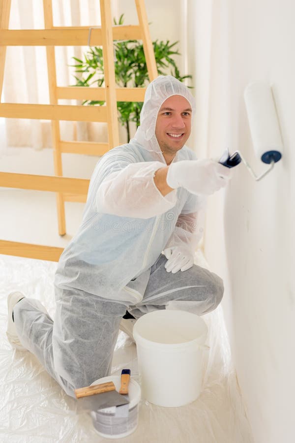 One Guy Whitewashing the Wall for Room Renovation Stock Image - Image ...
