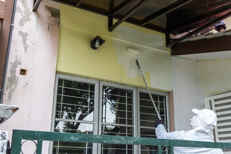 Painter Worker Adding Undercoat Foundation Paint Onto Wall with Roller ...