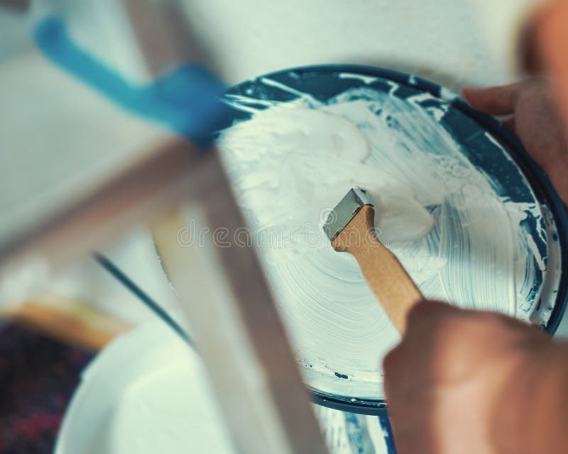 Painter Working with Paint Roller and Brushes To Paint the Room Stock ...