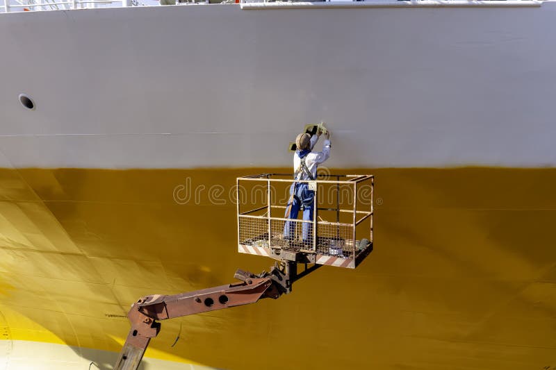 Painting the Bow of a Big Container Ship Inside Dry Dock Stock Image ...