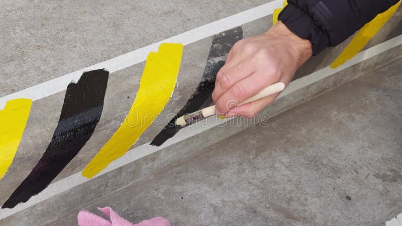 Painting Concrete Step with Black and Yellow Lines, Indicating ...