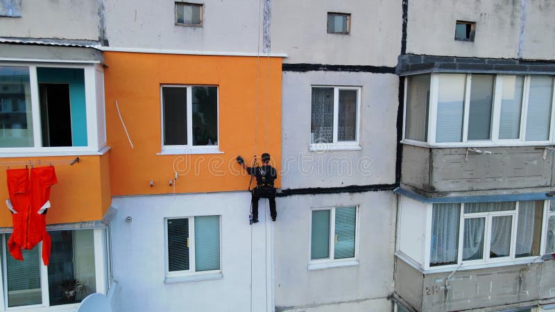 Painting and Decorating Buildings. Worker on a Construction Site of a ...