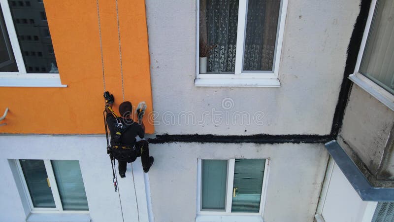 Painting and Decorating Buildings. Worker on a Construction Site of a ...