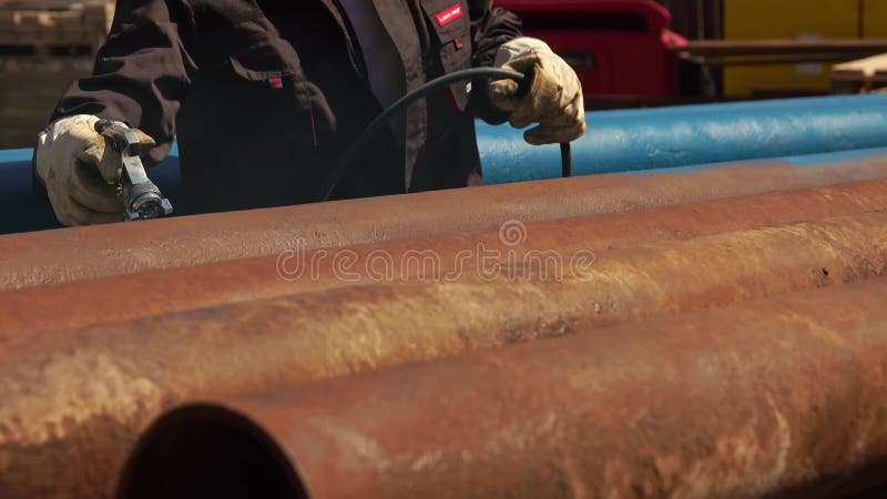 Painting of Metal Pipe with Paint Roller. the Hand of a Painter with a ...