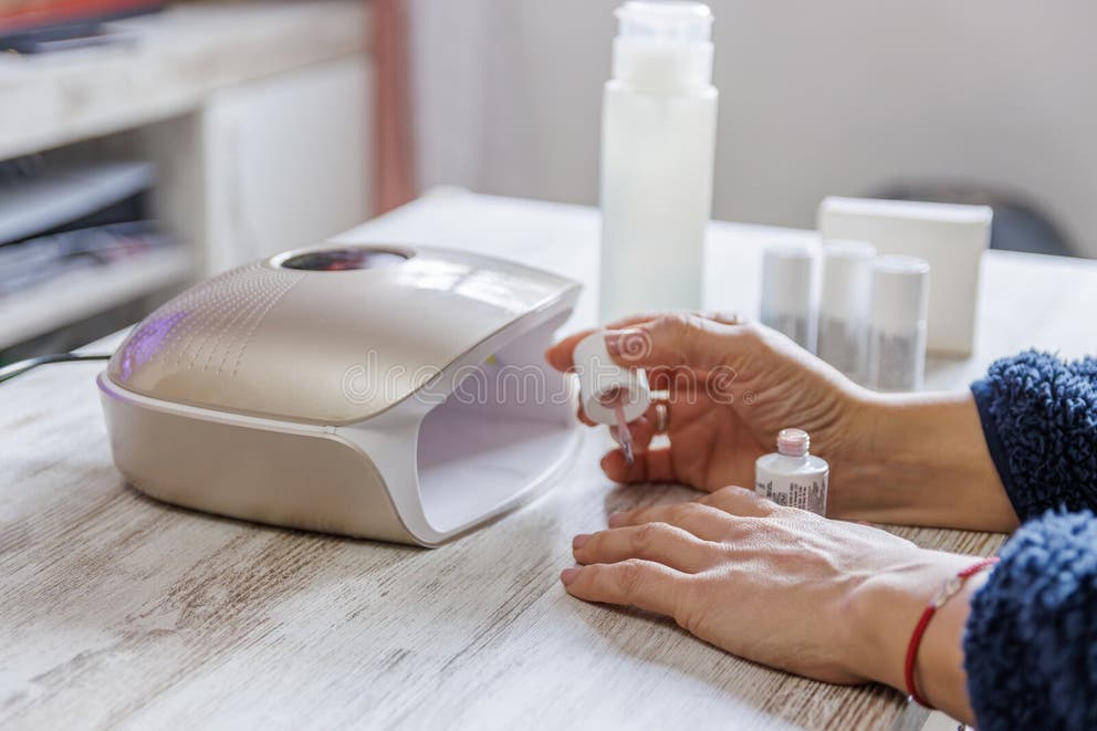 Painting Nails with Permanent Paint and Drying Machine Stock Photo ...