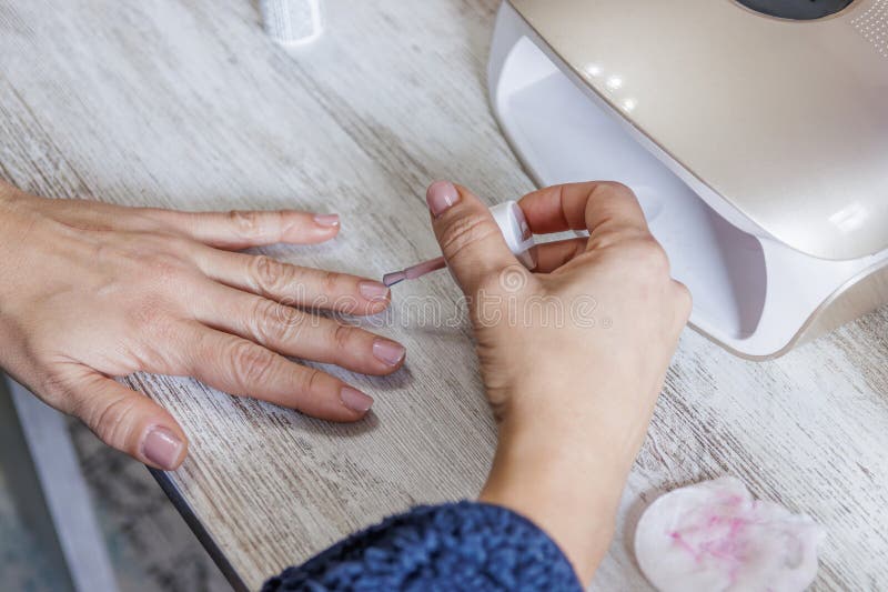 Painting Nails with Permanent Paint and Drying Machine Stock Image ...