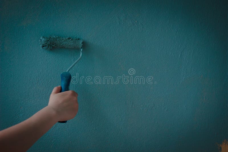 Painting Wall by Aqua Color Paints with Paint Roll. Stock Image - Image ...