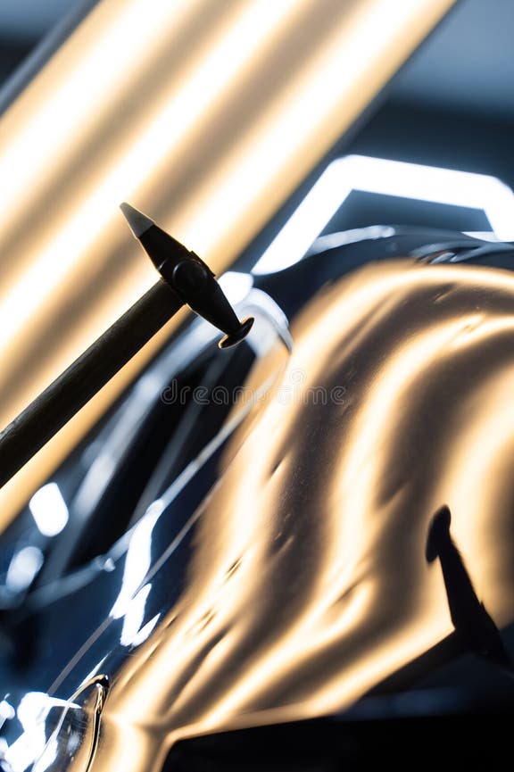 Paintless Dent Repair PDR Involves Tapping Dents Under Light Reflection ...