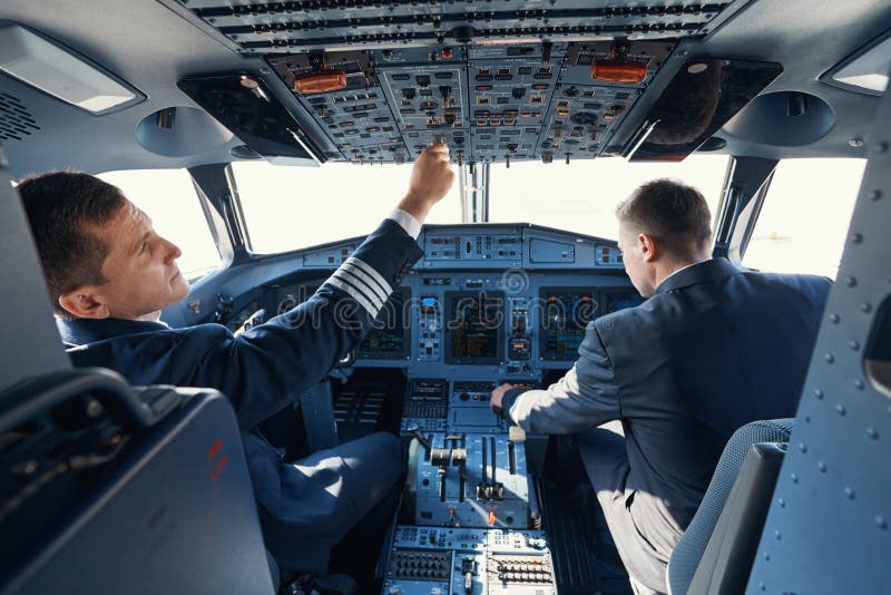 Pair of Aircraft Pilots Toggling Switches while Taking-off Stock Photo ...