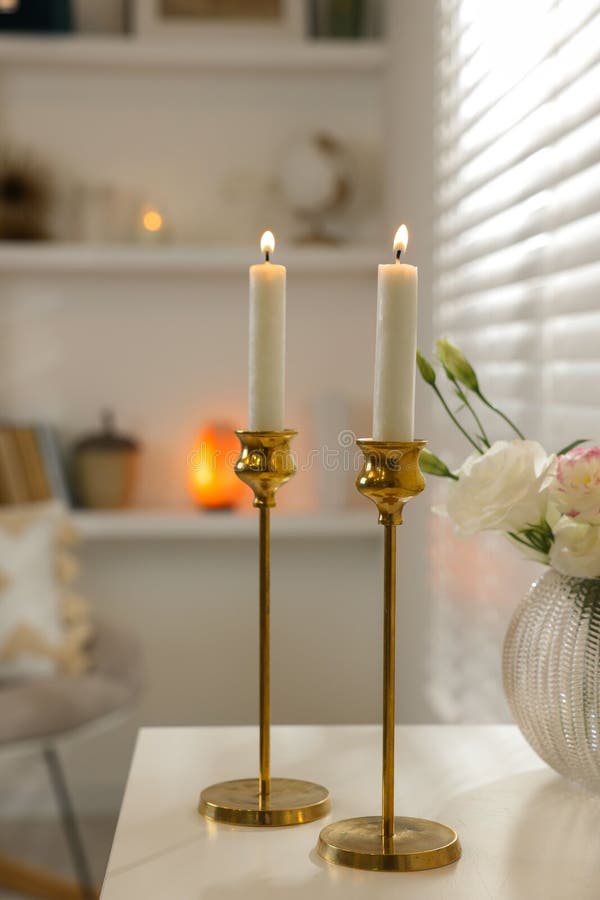 Pair of Beautiful Golden Candlesticks on White Table in Room Stock ...