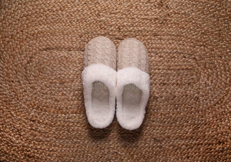 Pair of Beautiful Soft Slippers on Wicker Carpet, Top View Stock Photo ...