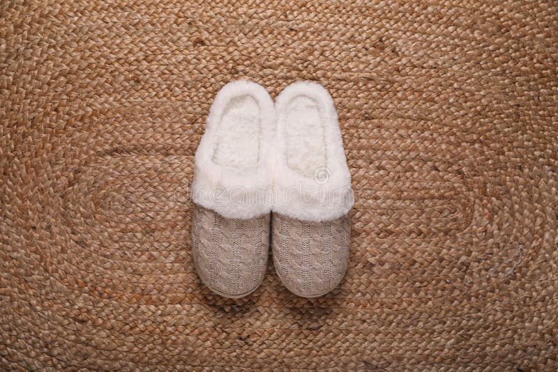 Pair of Beautiful Soft Slippers on Wicker Carpet, Top View Stock Photo ...