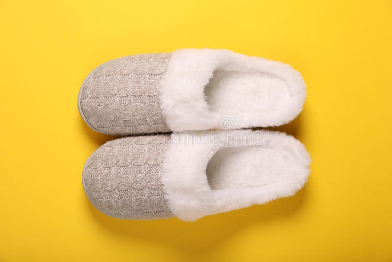 Pair of Beautiful Soft Slippers on Yellow Background, Top View Stock ...