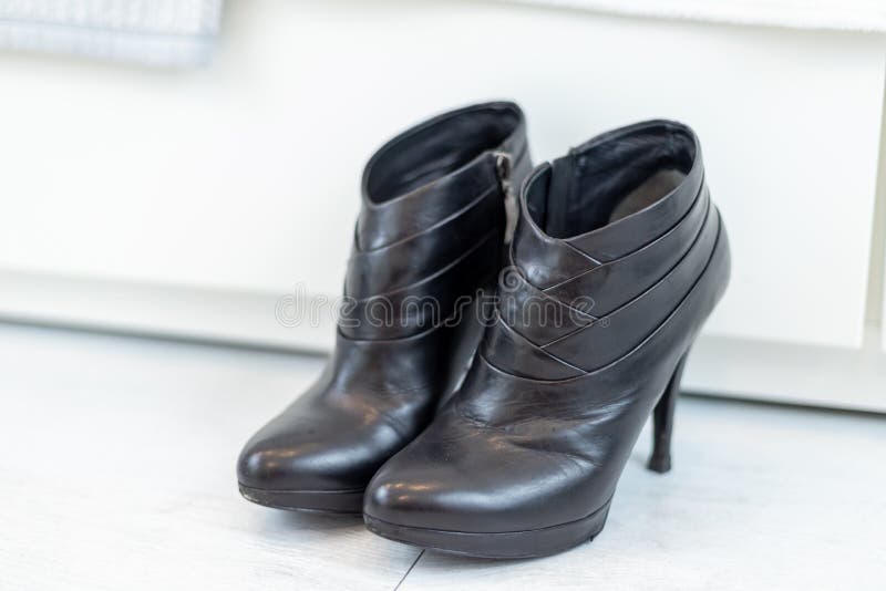 Pair of Black Boots with High Heels in Front of a White Closet Stock ...