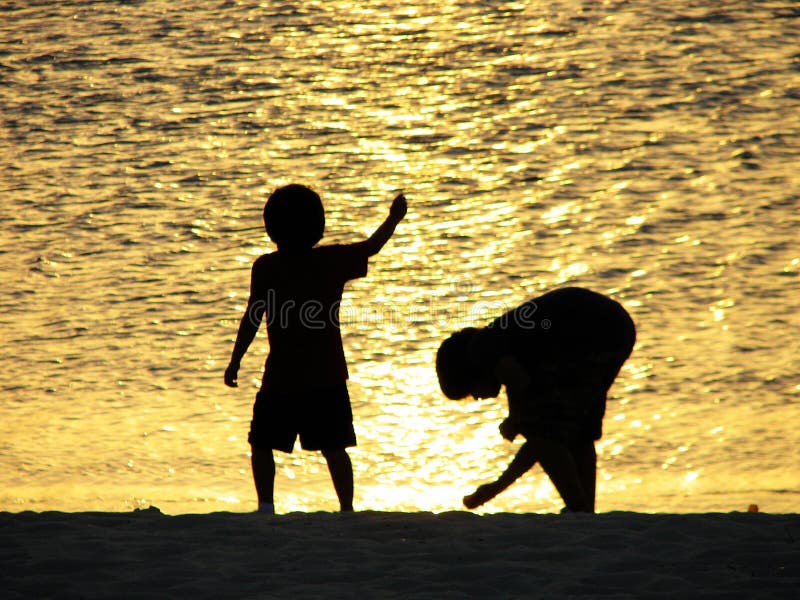Pair of Boys Playing at Sunset on the Beach Stock Image - Image of ...
