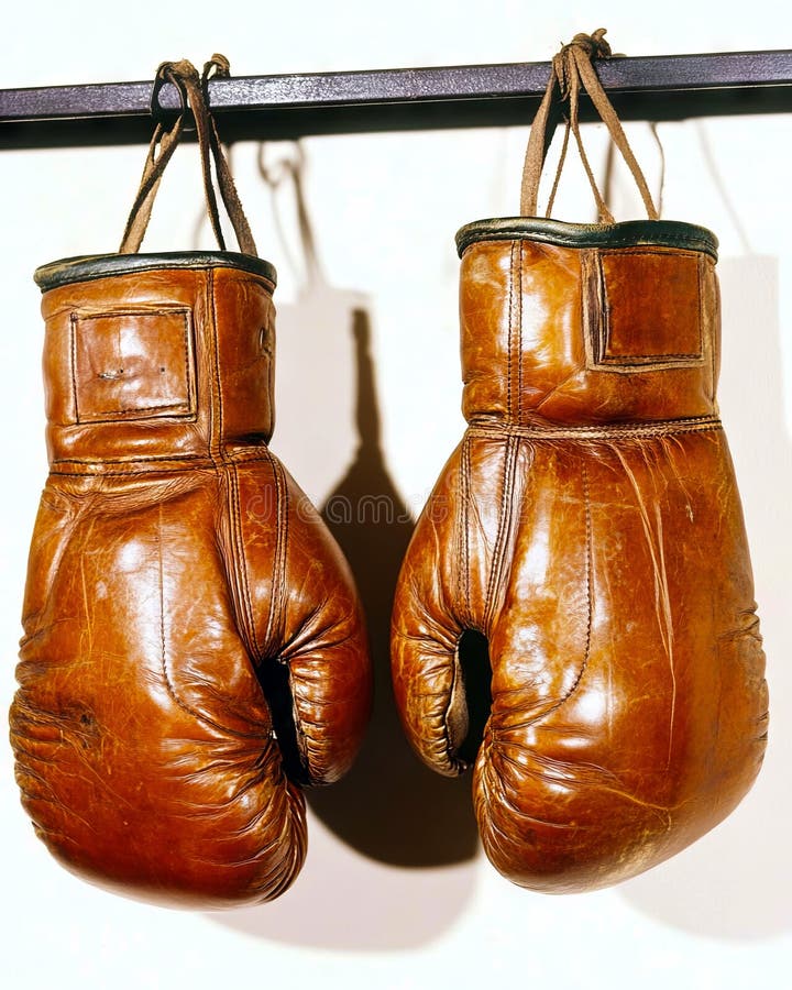 A Pair of Brown Leather Boxing Gloves Hanging on a Wall Stock Photo ...