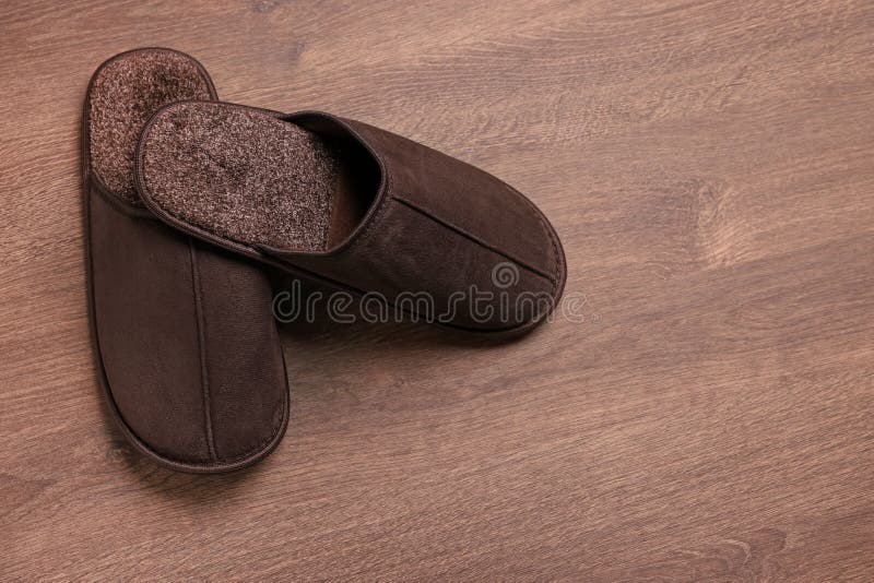 Pair of Brown Slippers on Wooden Floor, Top View. Space for Text Stock ...