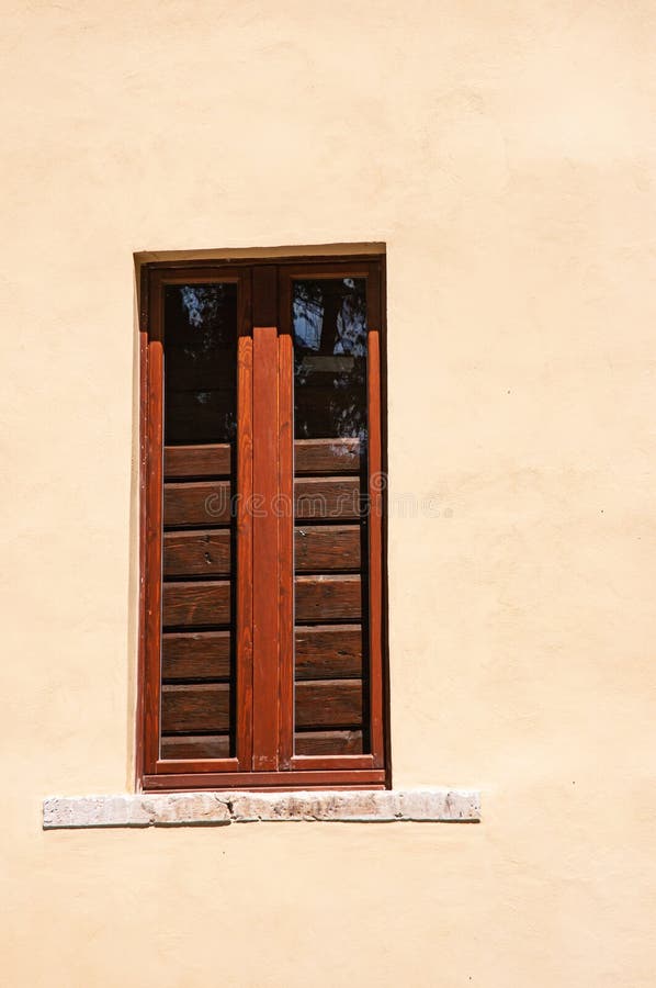 Pair of Closed, Brown, Tall, Wood Shutters with a Glass Pane in Each ...