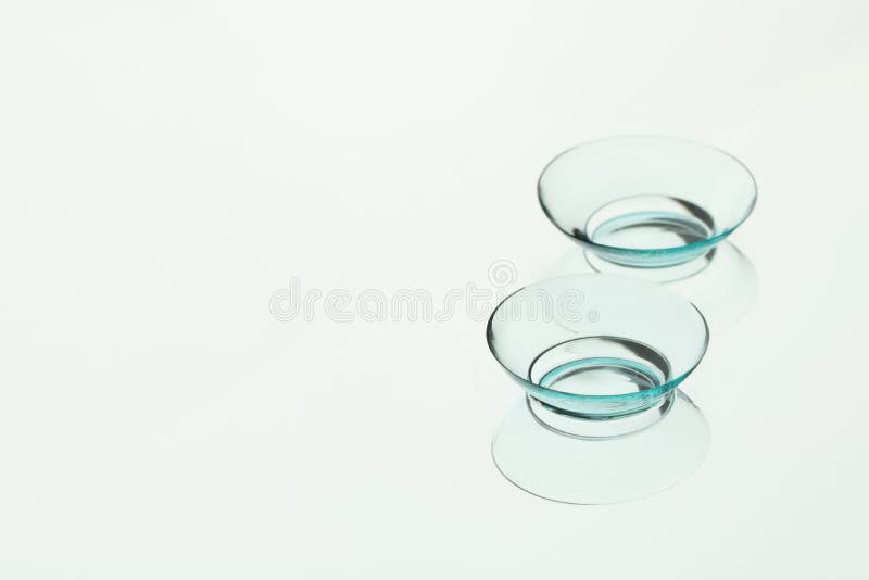 Pair of Contact Lenses on White Reflective Surface. Space for Text ...