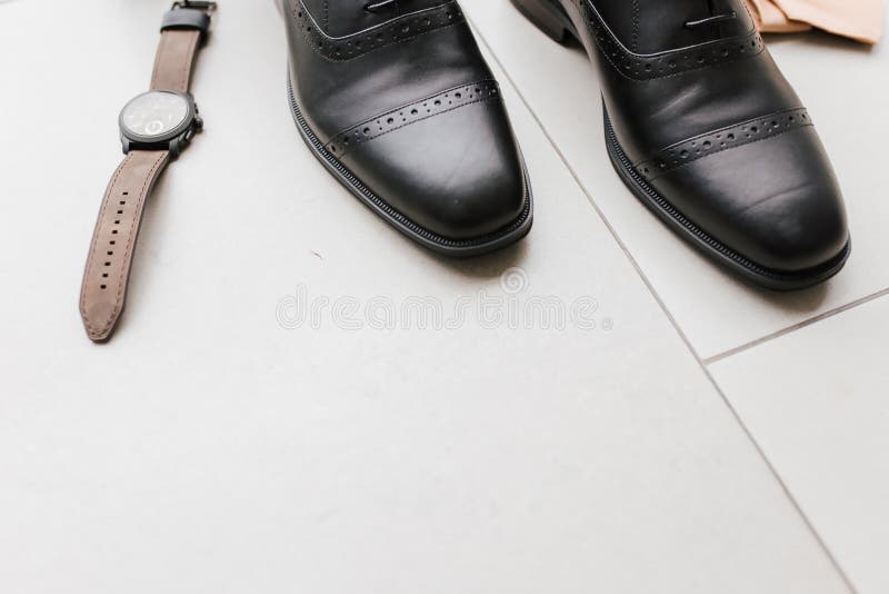 A Pair of a Executive Man Shoes and a Brown Watch with Empty Space ...