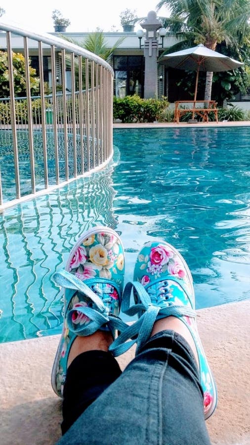 A Pair of Feet in Beautiful Blue Shoes Relaxing by the Pool Stock Photo ...