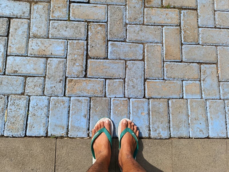 A Pair of Feet with Blue Paving Blocks Stock Image - Image of blue ...