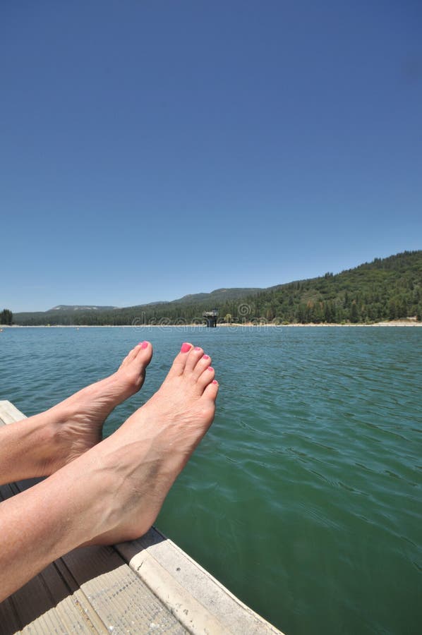 A Pair of Feet on Dock by Lake Stock Photo - Image of waiting, feet ...