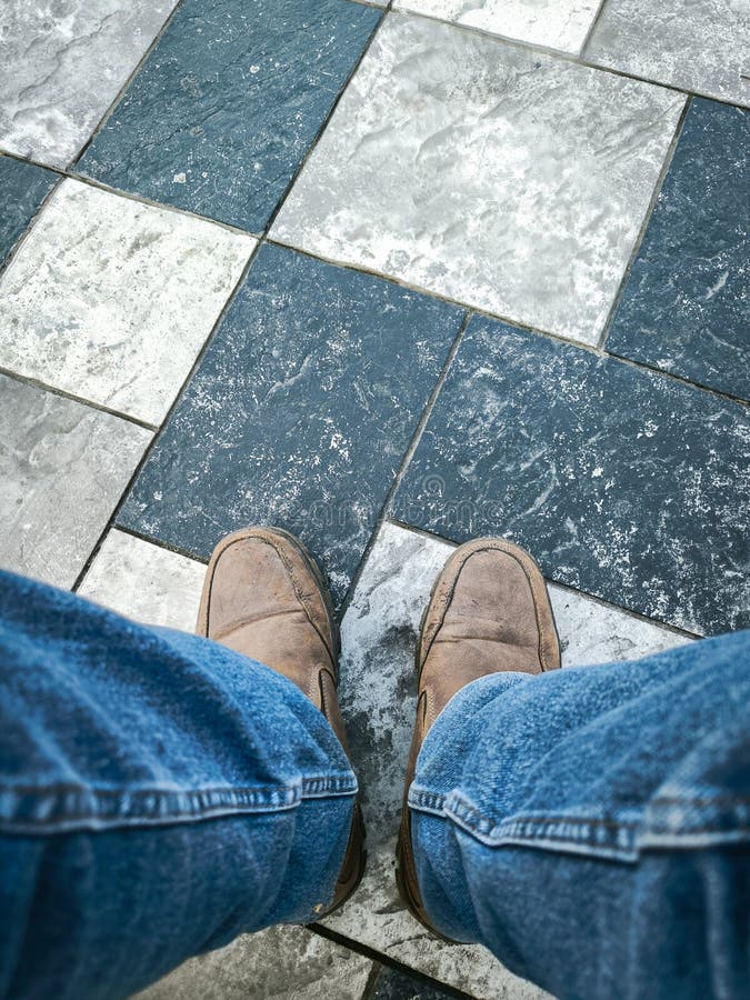 Pair of Feet in Jeans and Shoes on Tile Floor Stock Image - Image of ...