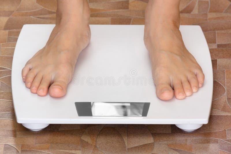 Pair of Female Feet Standing on the Scale Stock Image - Image of ...