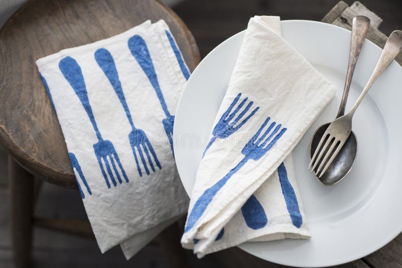 Pair of Fork-Patterned Dinner Napkins on Plate and Stool Stock Image ...