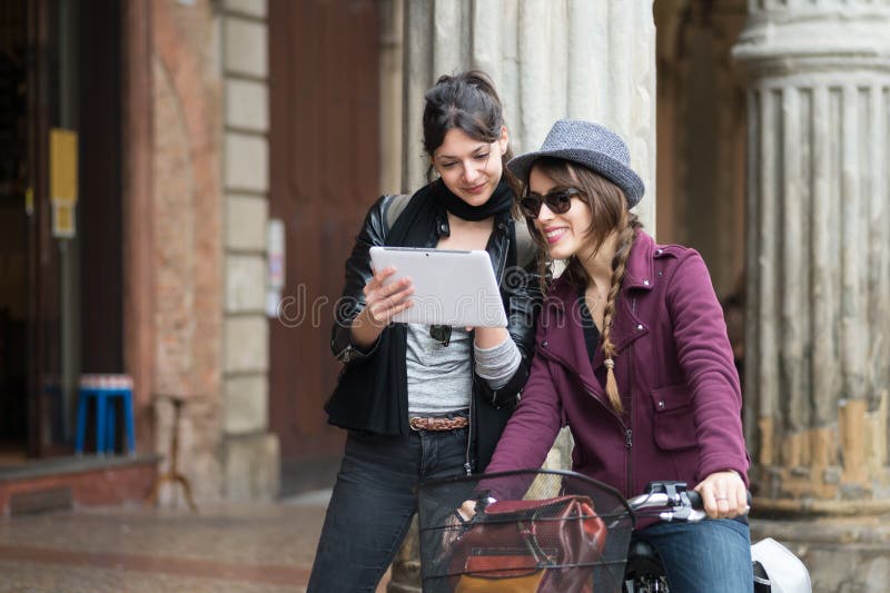 Pair of girls use tablet stock photo. Image of italy - 90389086