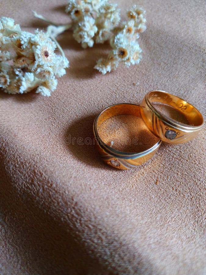 A Pair of Gold Wedding Rings Stock Photo - Image of detail, brown: 79856730