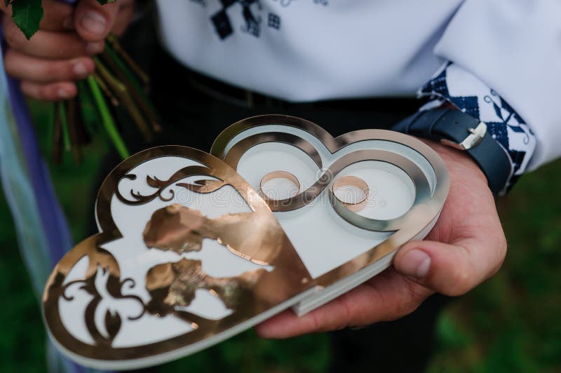 A Pair of Gold Wedding Rings on a Heart-shaped Stand. Wedding Ceremony ...