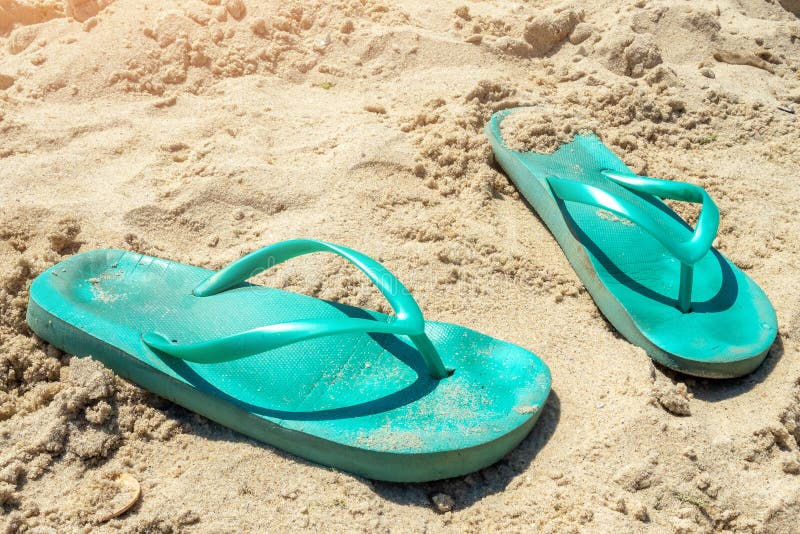 A Pair of Green Shabby Slippers on the Hot Beach Sand Stock Photo ...