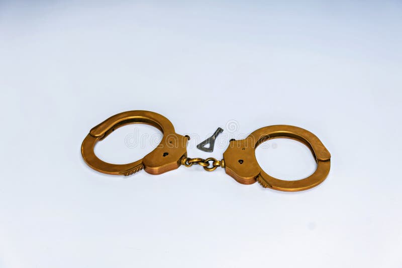 A Pair of Handcuffs on a White Surface Stock Image - Image of place ...