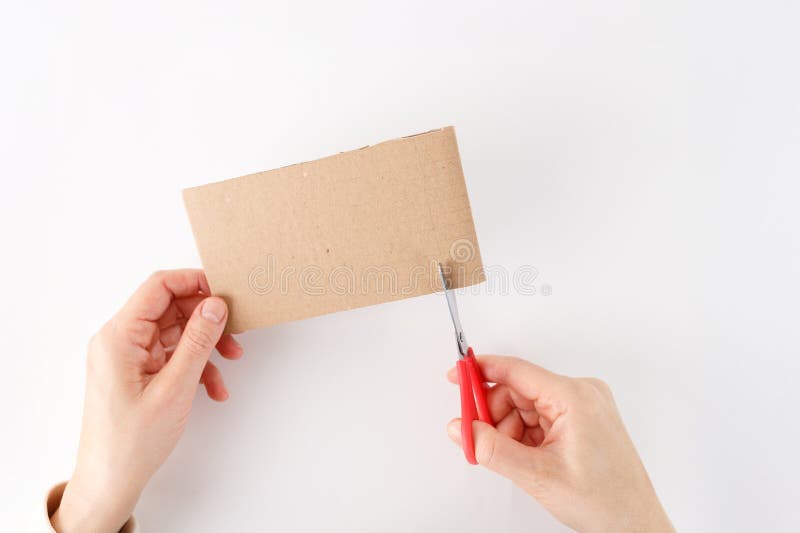 A Pair of Hands at Work, Cutting a Piece of Cardboard, Simple yet ...