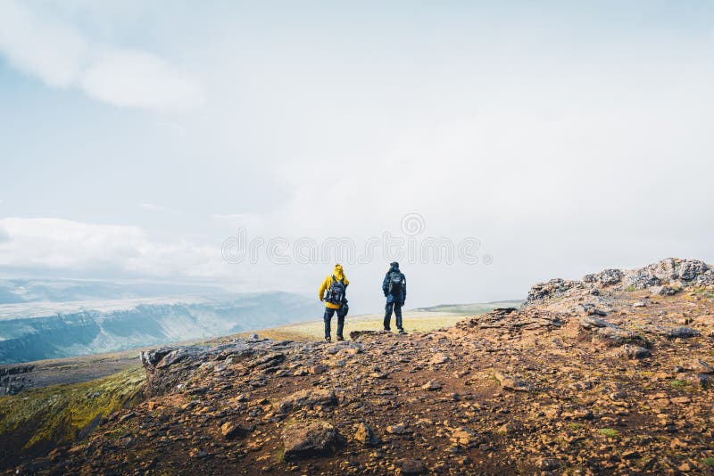 Pair of Hikers on a Summit Looking at the View of Glymur Waterfall in ...