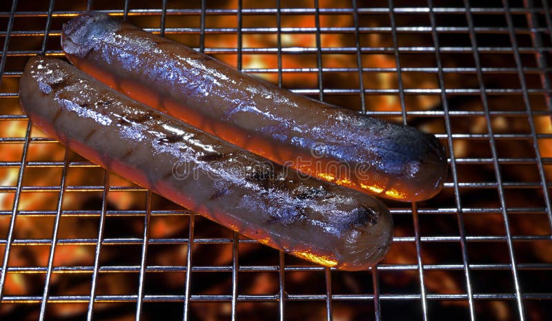 Pair of Hot Dogs that are Cooking Over a Fire Stock Photo - Image of ...