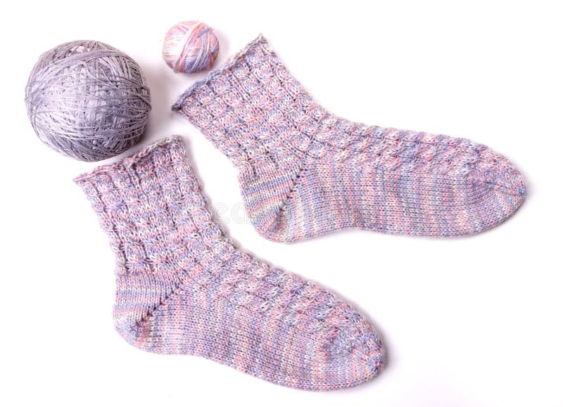 A Pair of Knitted Light Wool Socks. There are Two Balls of Wool Next To ...