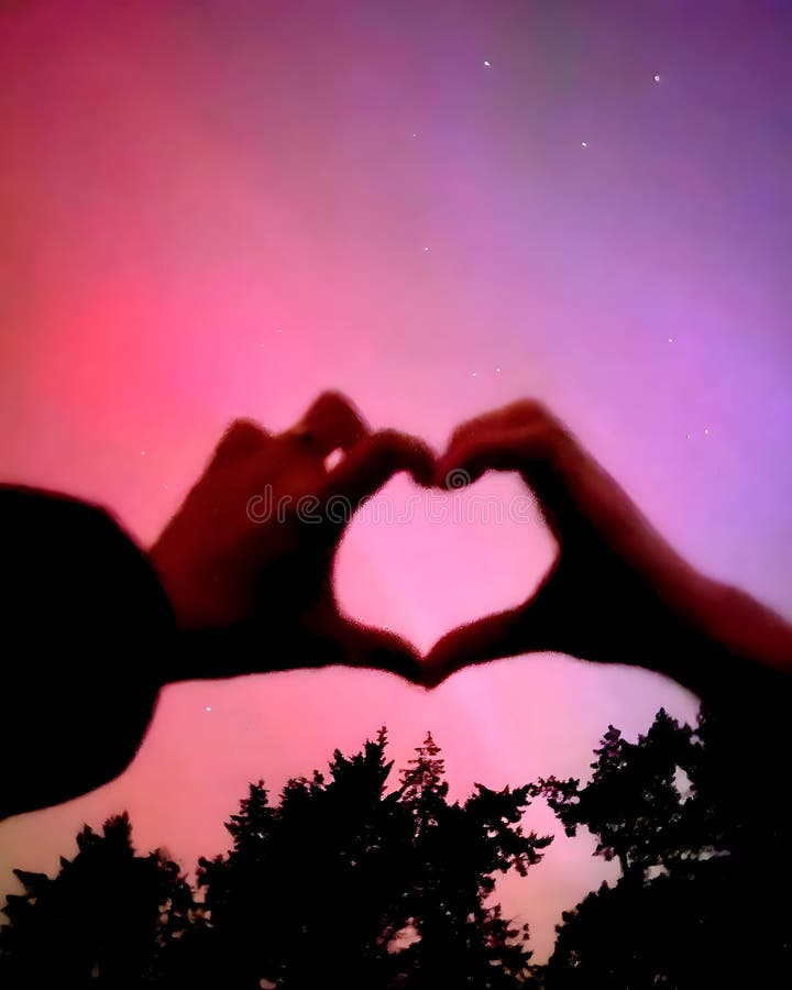 A Pair of Lovers Hands Form Love with an Aurora Background Stock ...