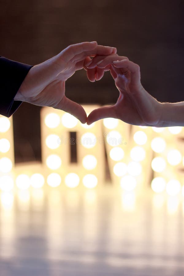 Pair of Lovers Making Heart with Hands. Stock Image - Image of lights ...