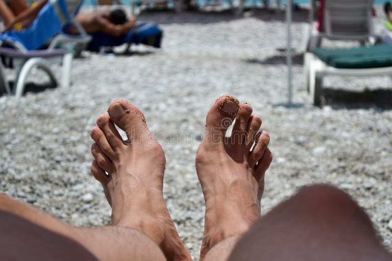 A Pair of Male Legs. Man Resting on the Beach Stock Photo - Image of ...