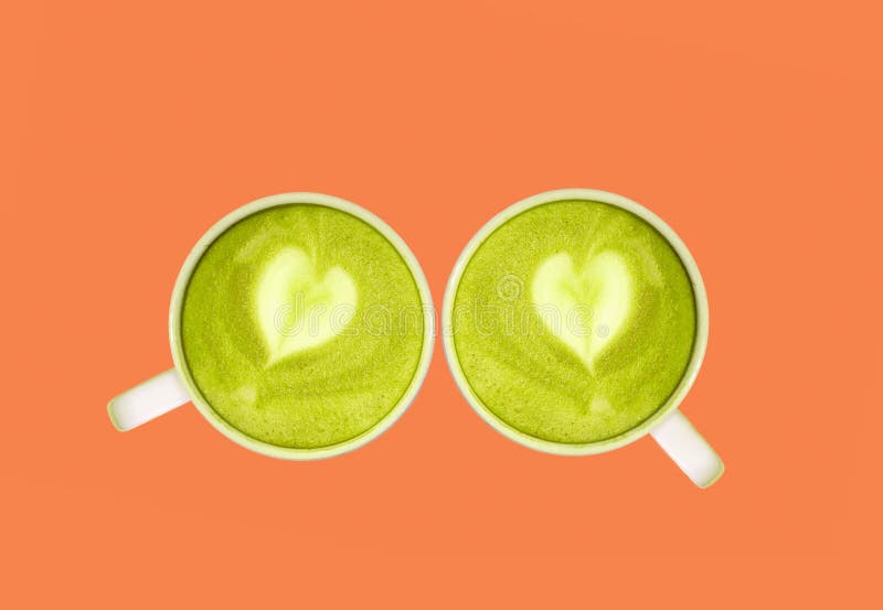 Pair of Matcha Green Tea with Heart Shaped Latte Art on Orange Backdrop ...